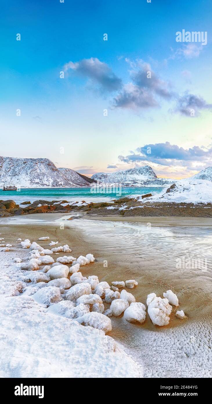 Fabulous winter scenery with Haukland beach during sunset and snowy ...