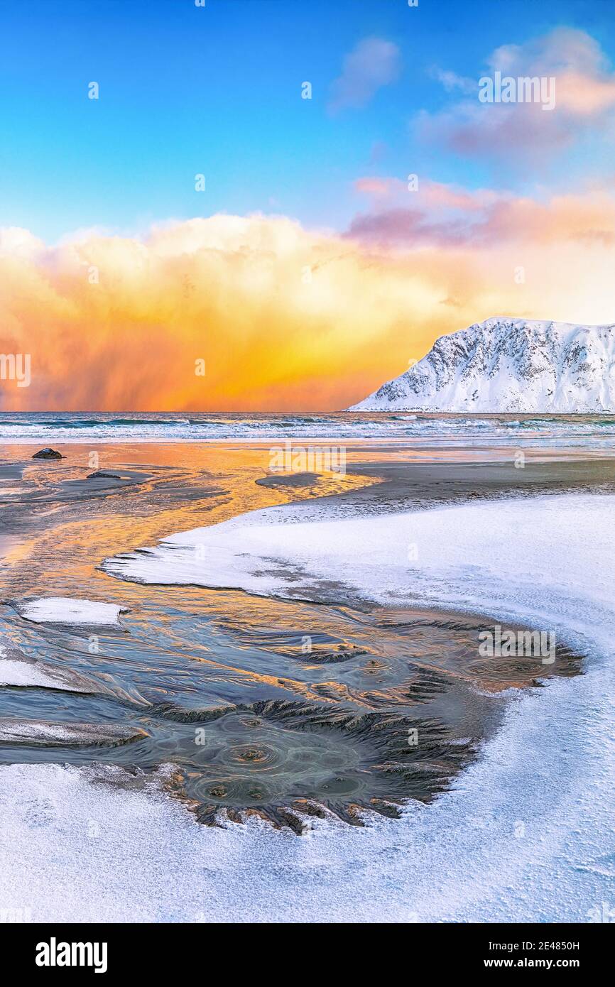 Outstanding winter scenery on Skagsanden beach with illuminated clouds during sunrise. Popular ...