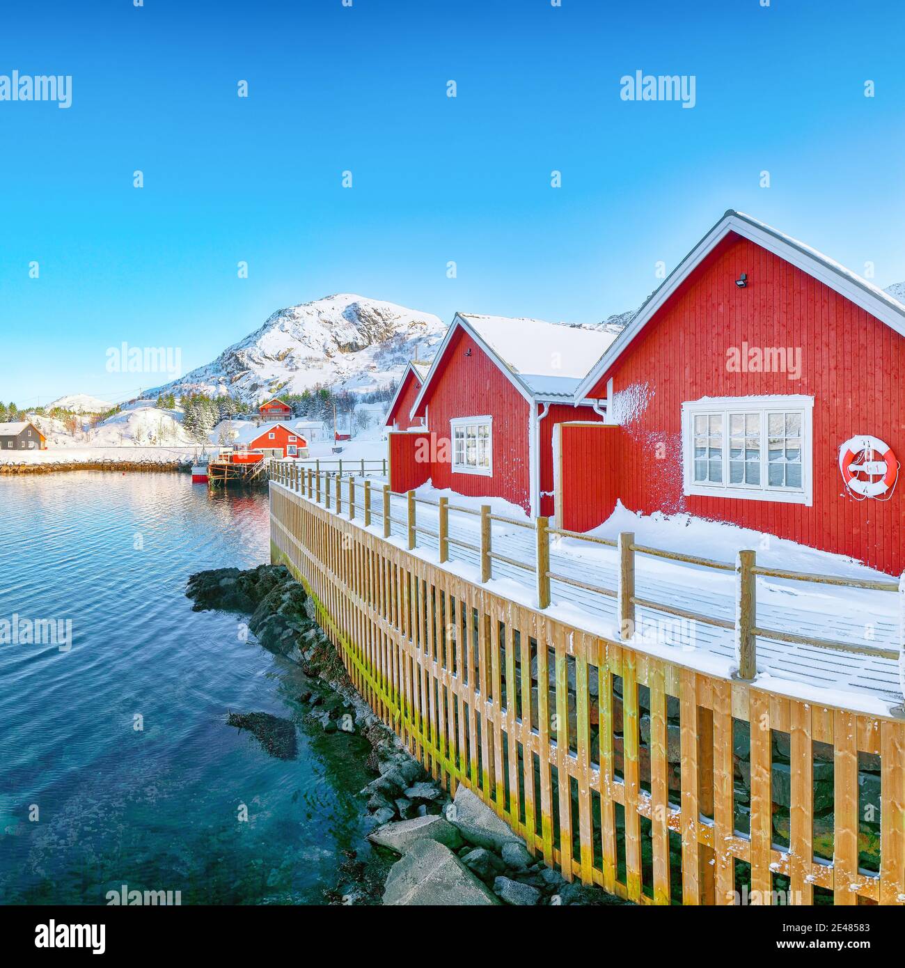 Traditional Norwegian red wooden houses on the shore of Sundstraumen ...