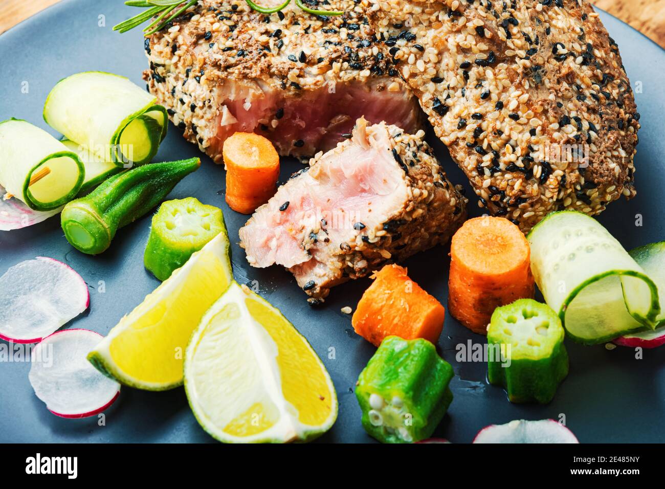Baked tuna steak with vegetable garnish.Fish cooked with vegetables ...