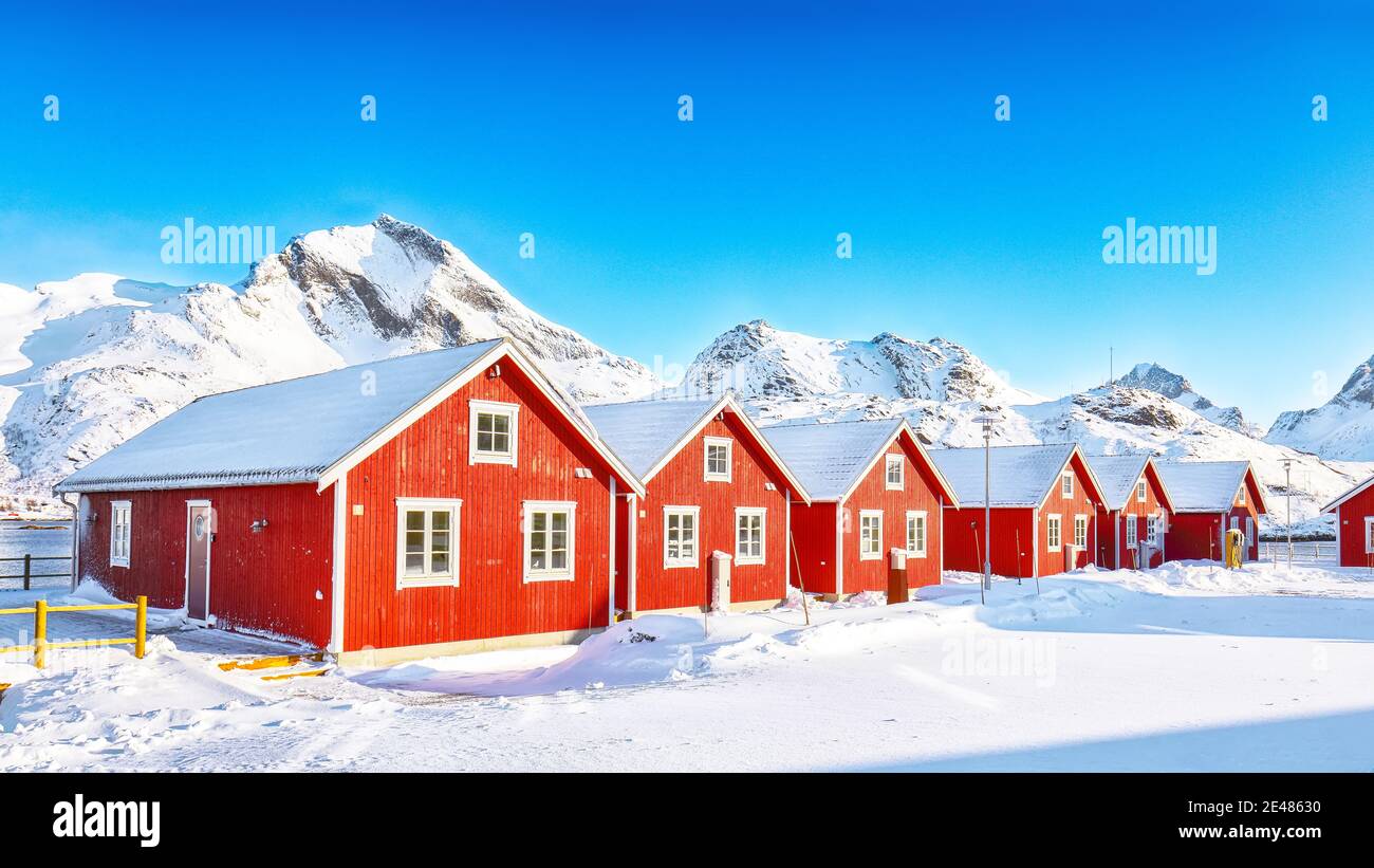 Astonishing winter scenery with traditional Norwegian red wooden houses ...