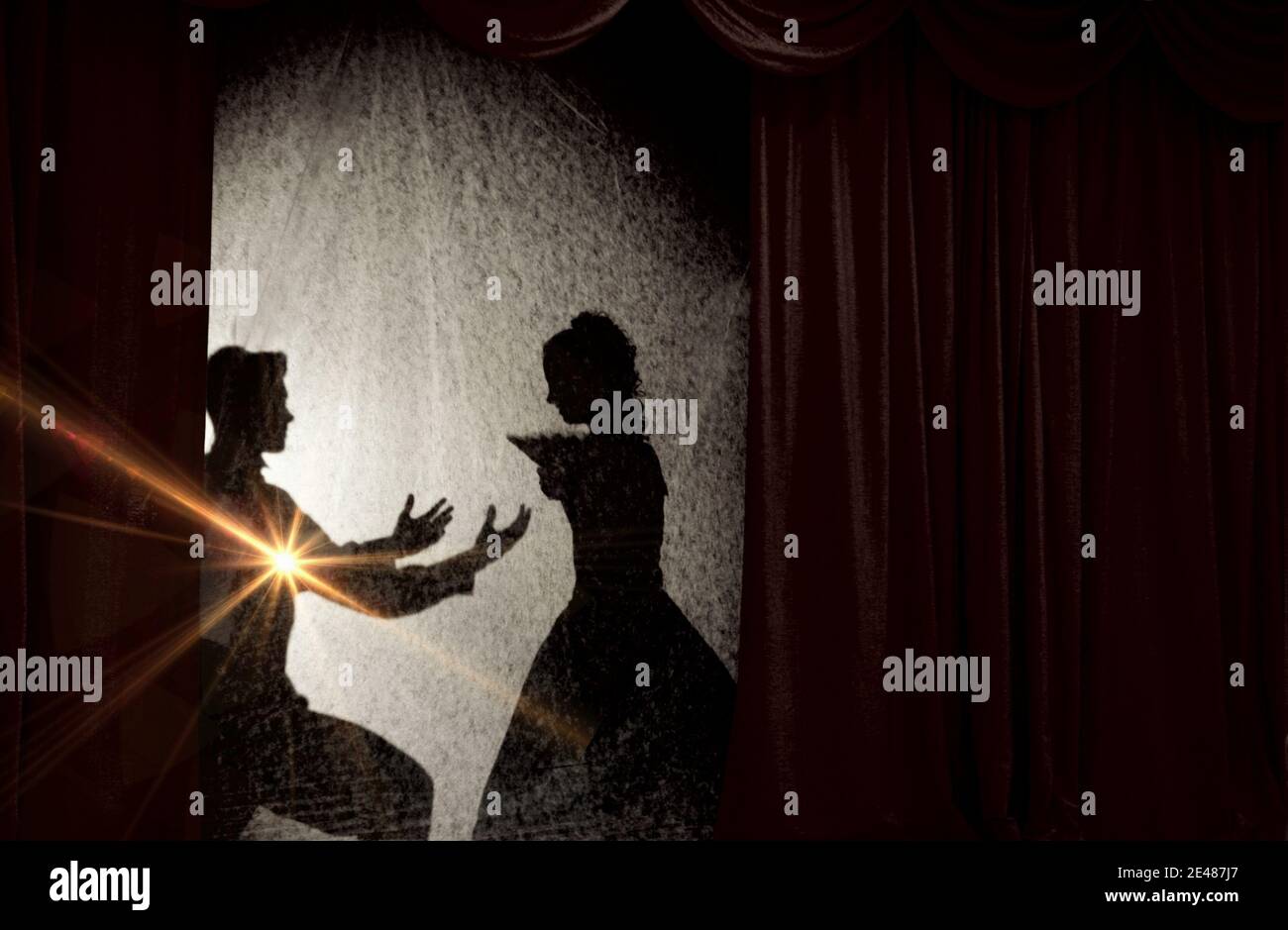 A man and woman in theatrical costumes in the theater of shadows on the ...