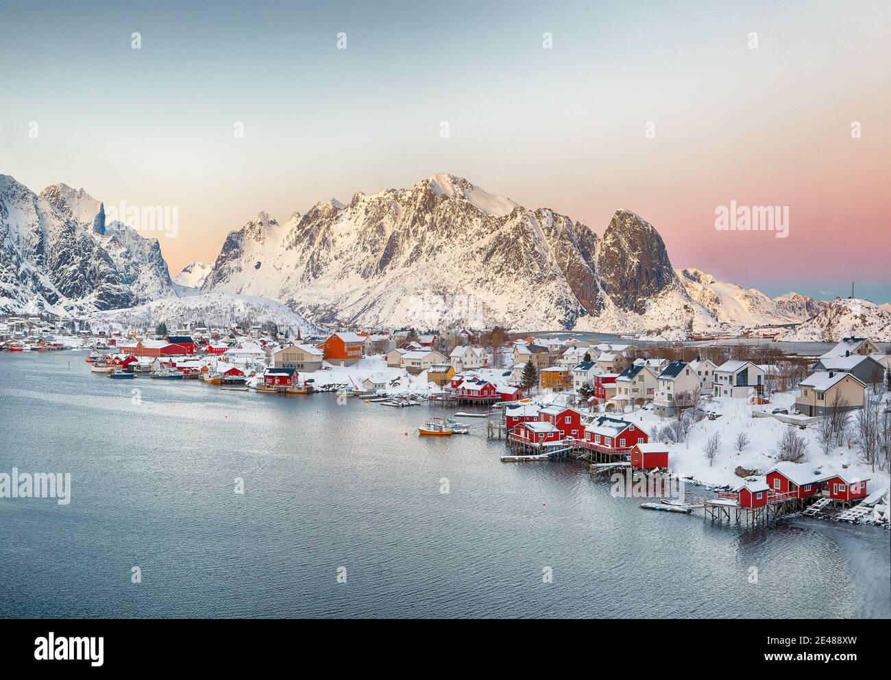 Fantastic evening panorama of Reine town. Red rorbuers on the shore of ...