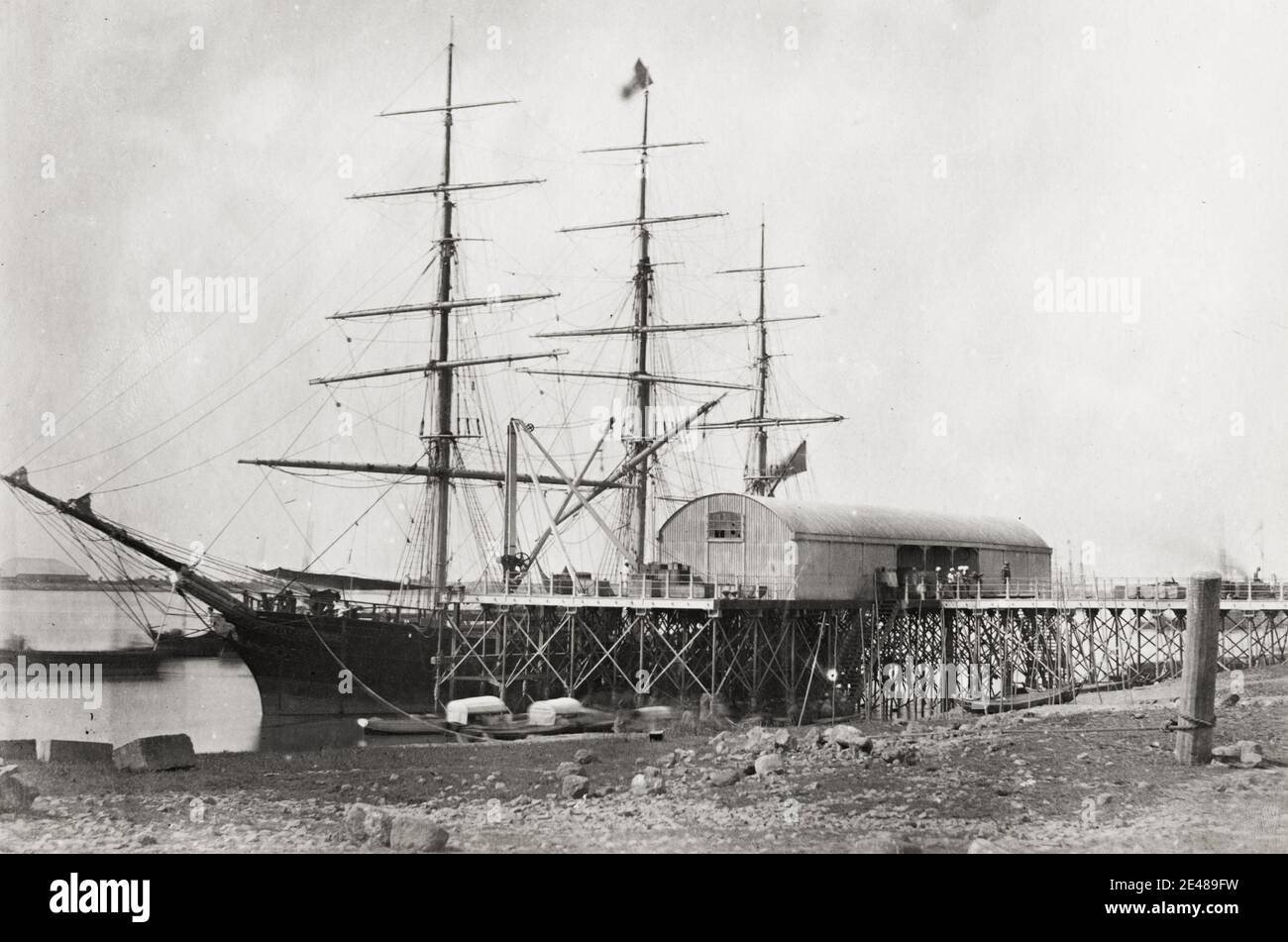 Vintage 19th century photograph: ship at iron wharf, scaffolding ...