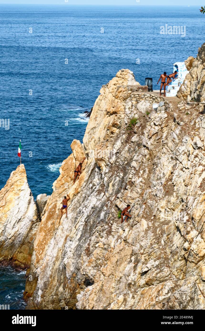 Cliff diver, a clavadista, diving off the cliffs at La Quebrada ...
