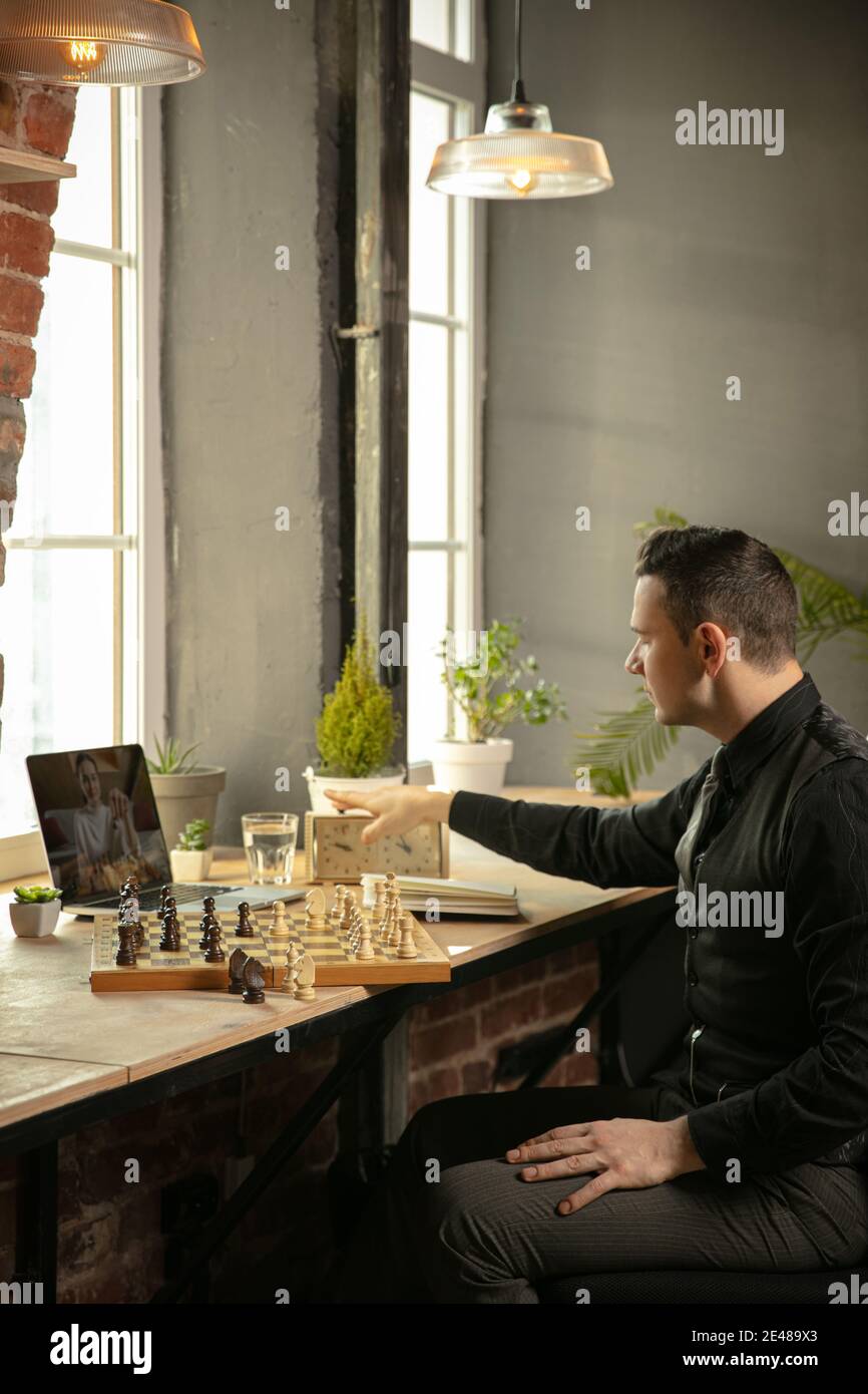 Serious Caucasian man chess player playing chess online with his ...
