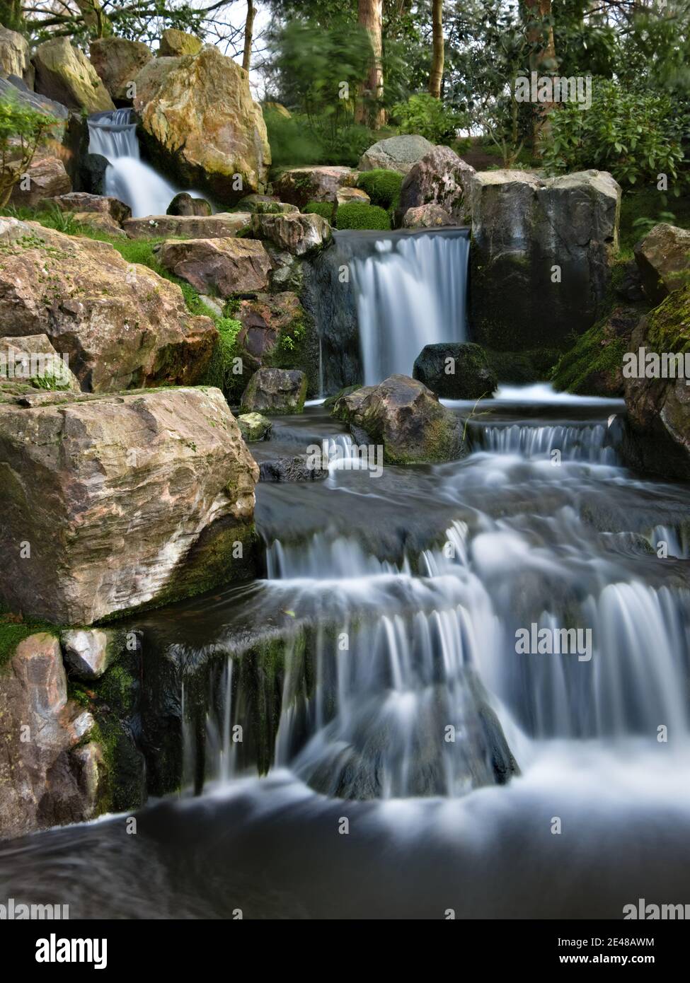 Long exposure silky smooth waterfall over rocky cliffs in Kyoto Garden ...