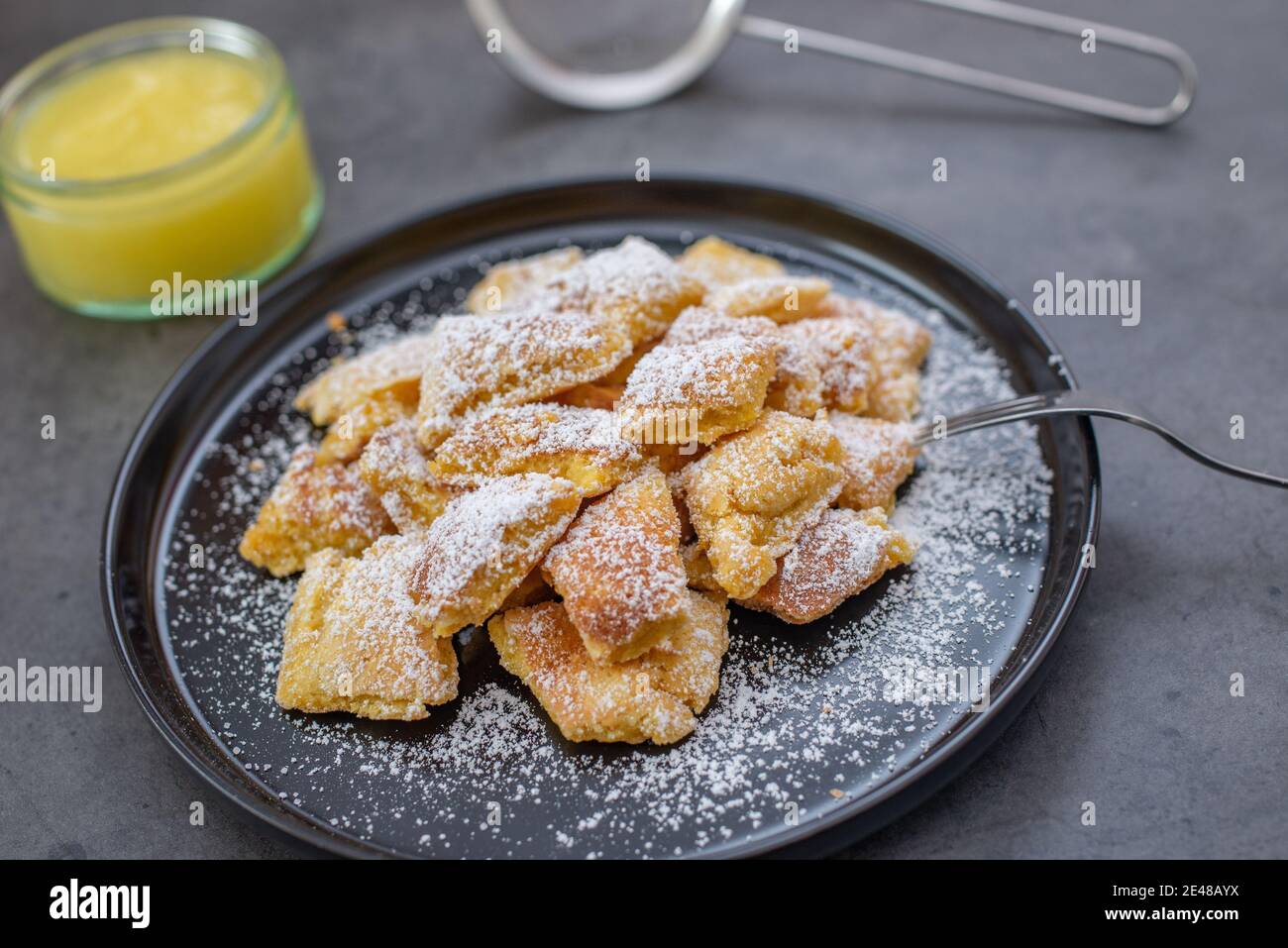 Austrian cuisine. Torn pancake (or omelet) kaiserschmarrn with honey ...
