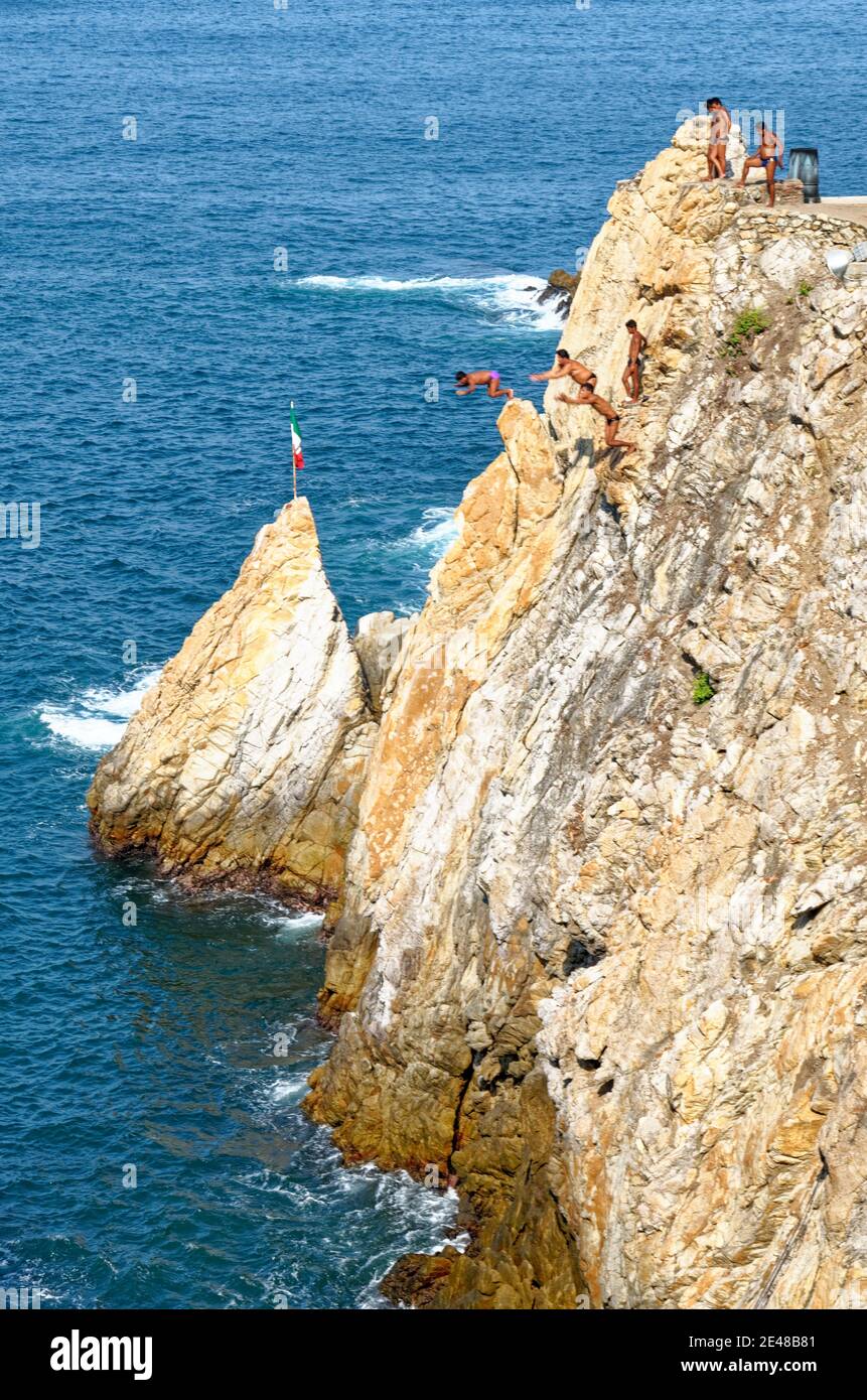Cliff diver, a clavadista, diving off the cliffs at La Quebrada ...