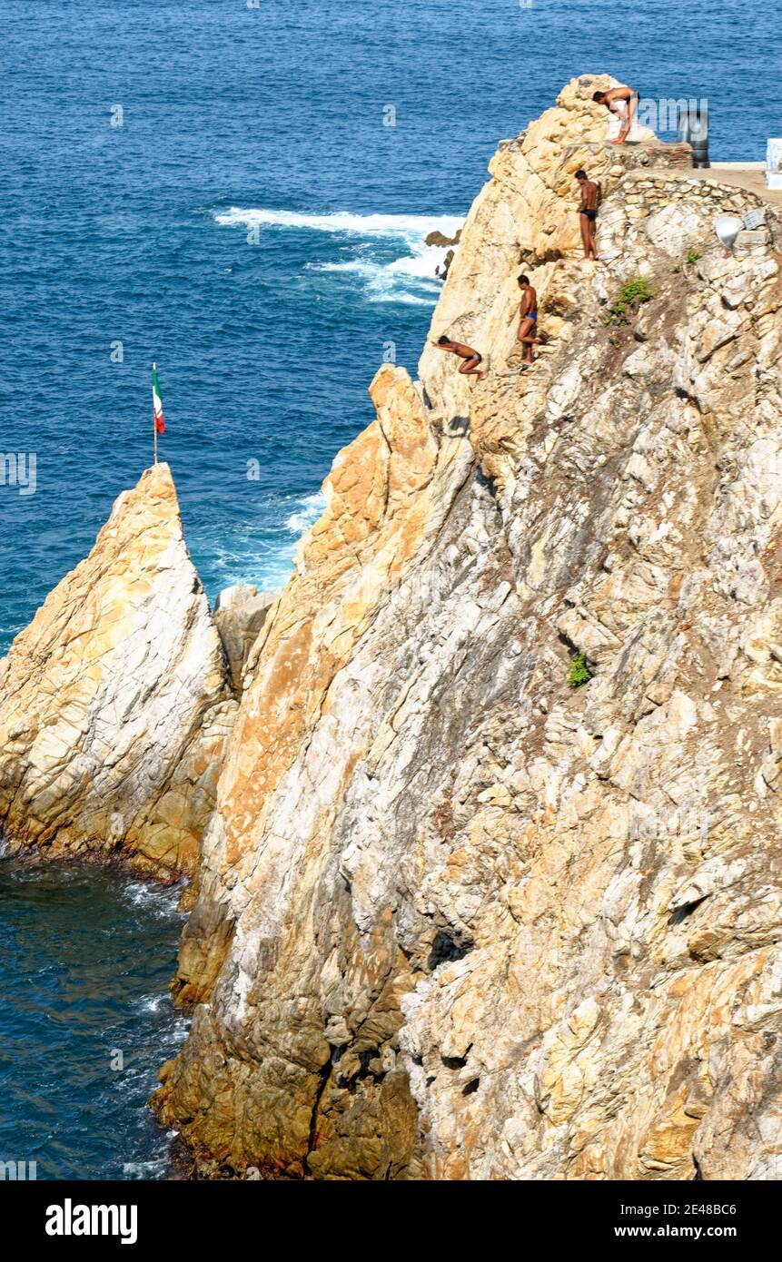 Cliff diver, a clavadista, diving off the cliffs at La Quebrada ...