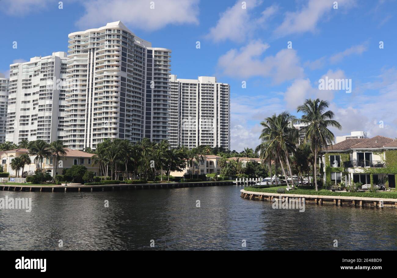 View of oceanside buildings and a luxury home with palm trees Stock ...