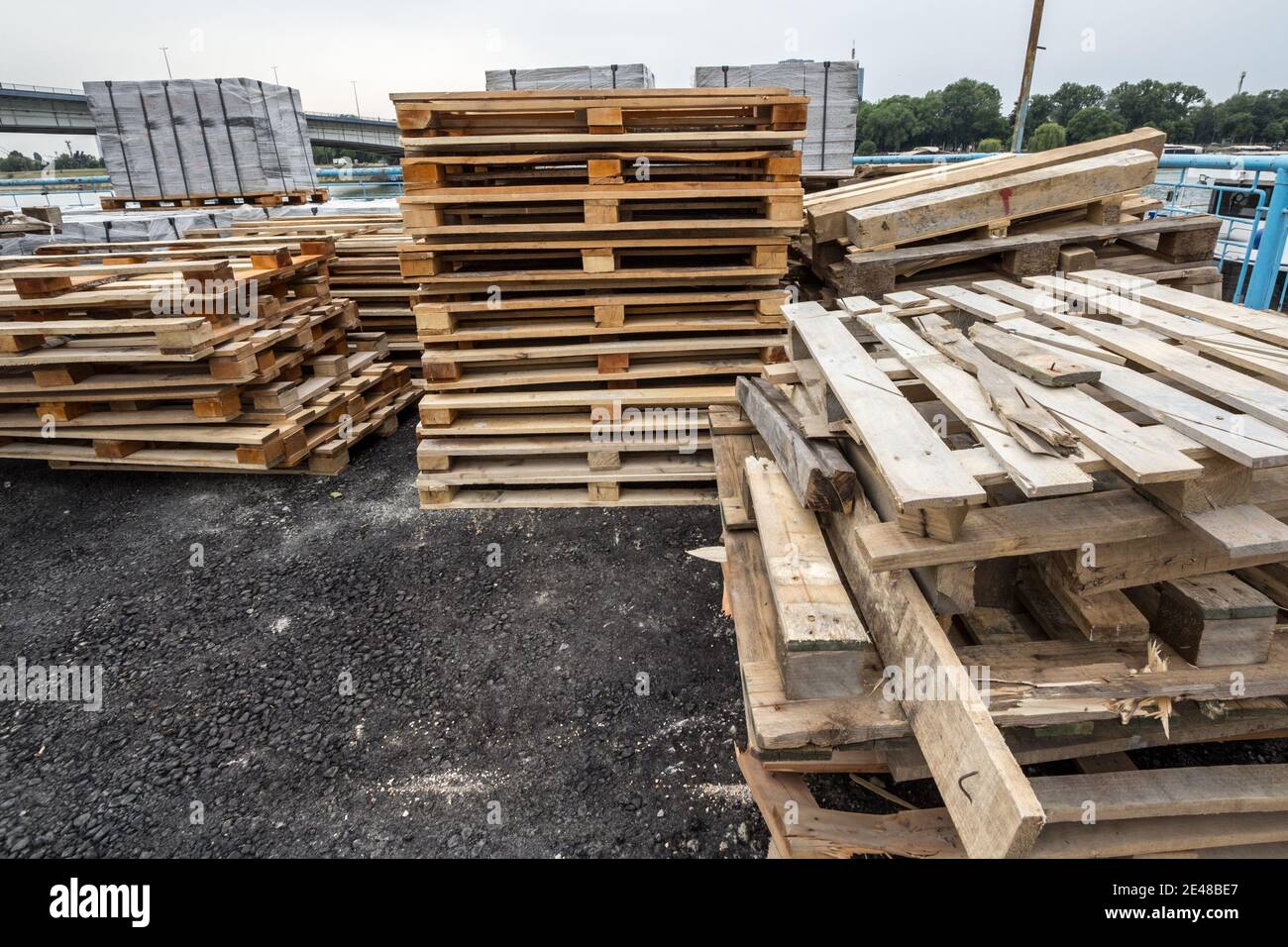 Pile of wooden pellets, some damaged, ready for recycling, stacked on a ...