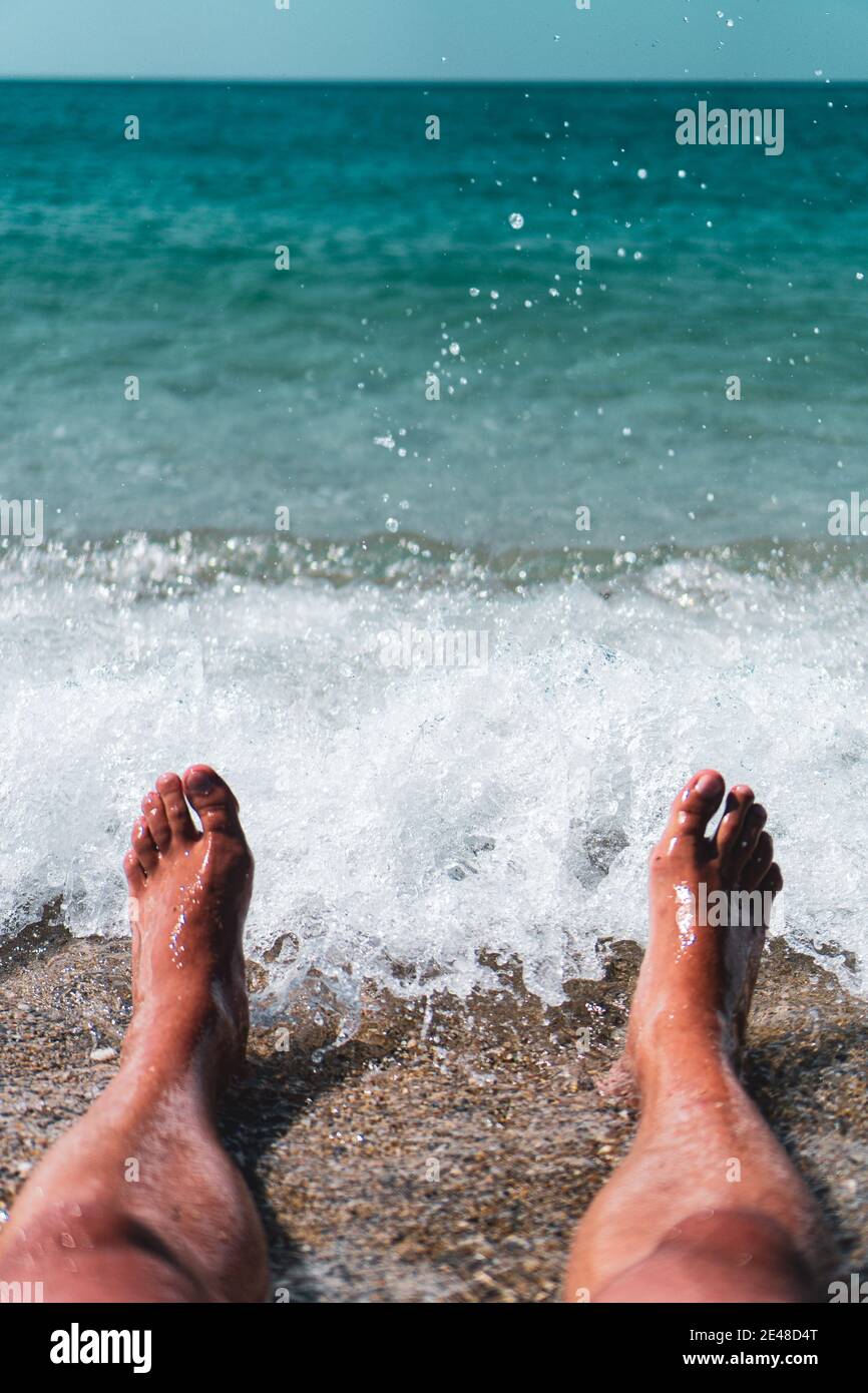 Man's feet facing waves Stock Photo - Alamy