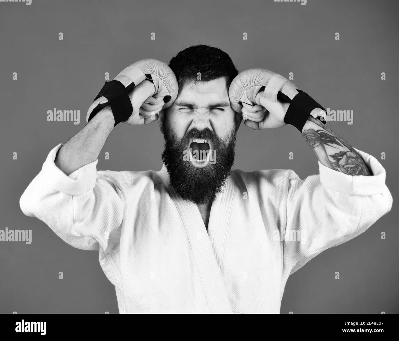 Combat master yells and hits his head. Oriental sports concept. Karate ...