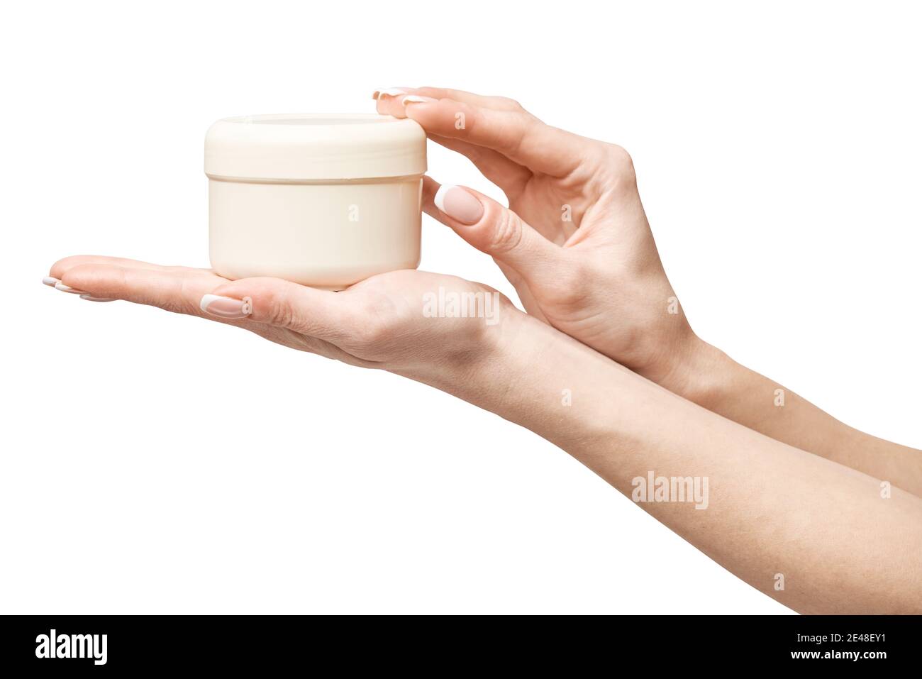 hand holding plastic can of cream Isolated on a white background Stock ...