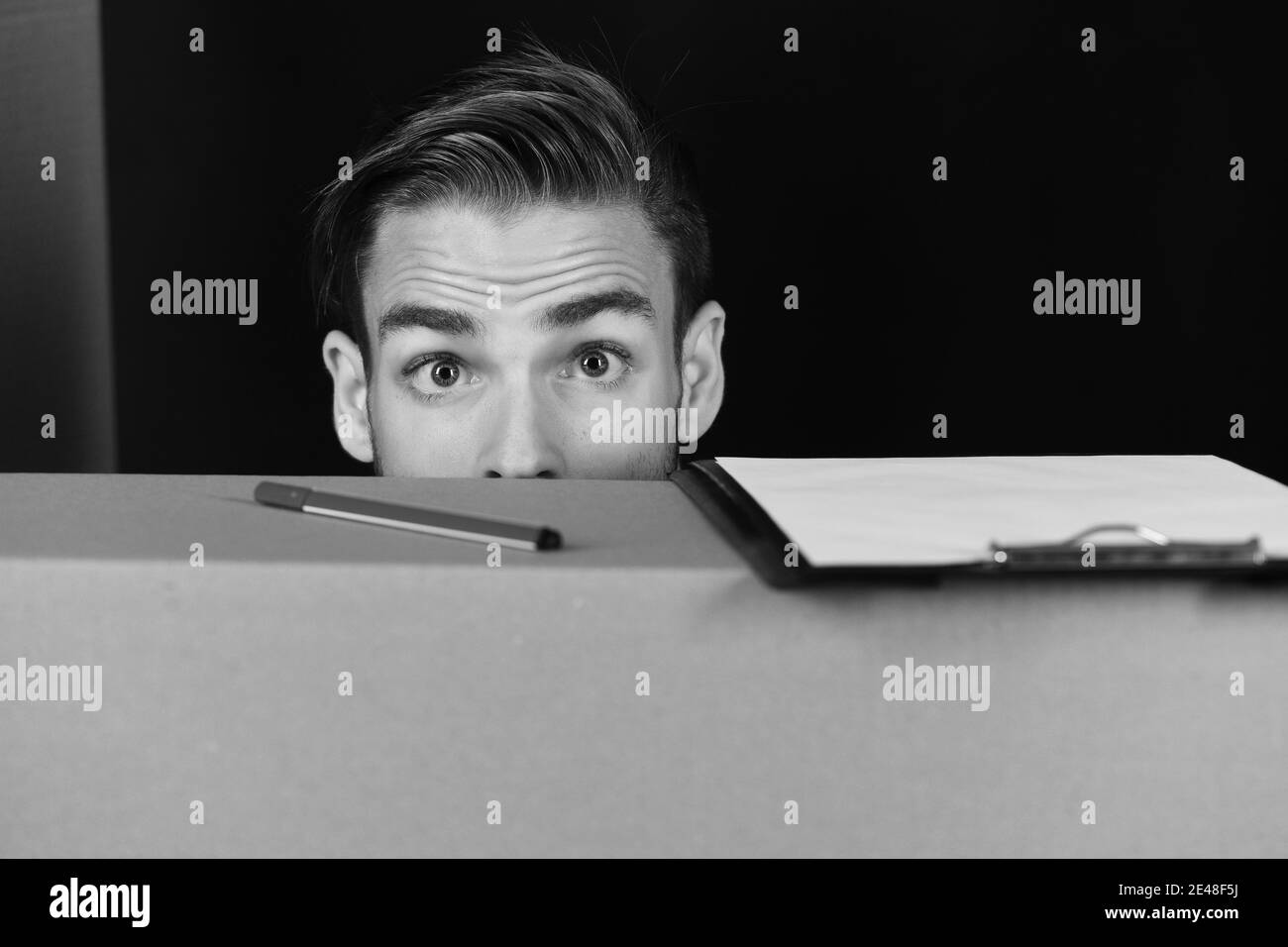 Man hiding behind cardboard boxes. Delivery and moving in concept ...