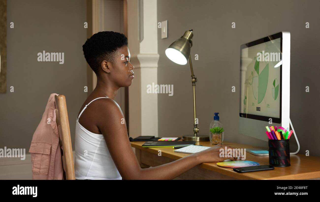 African american woman using computer while working from home Stock ...