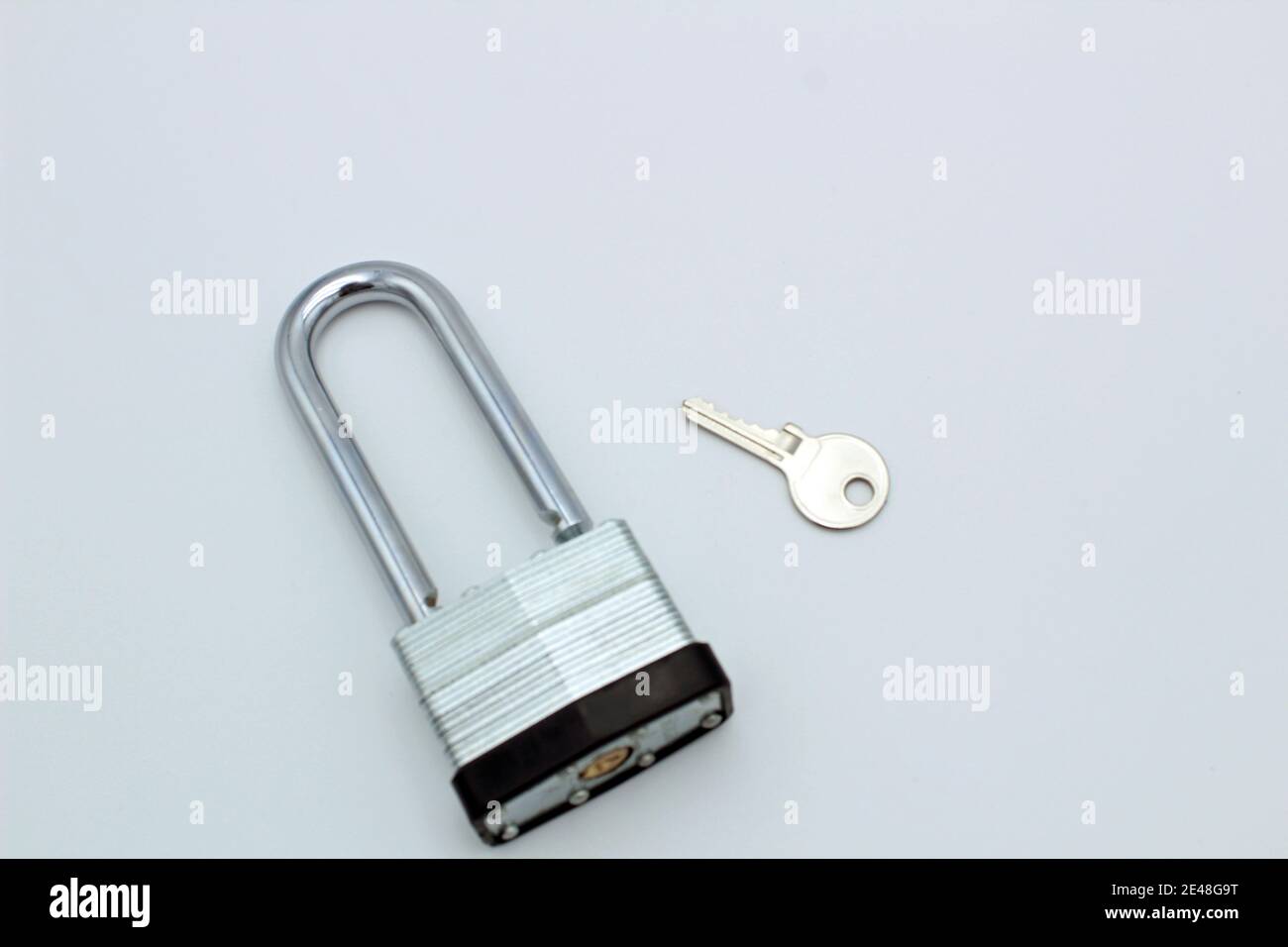 A steel padlock and key isolated on plain white background a concept of ...