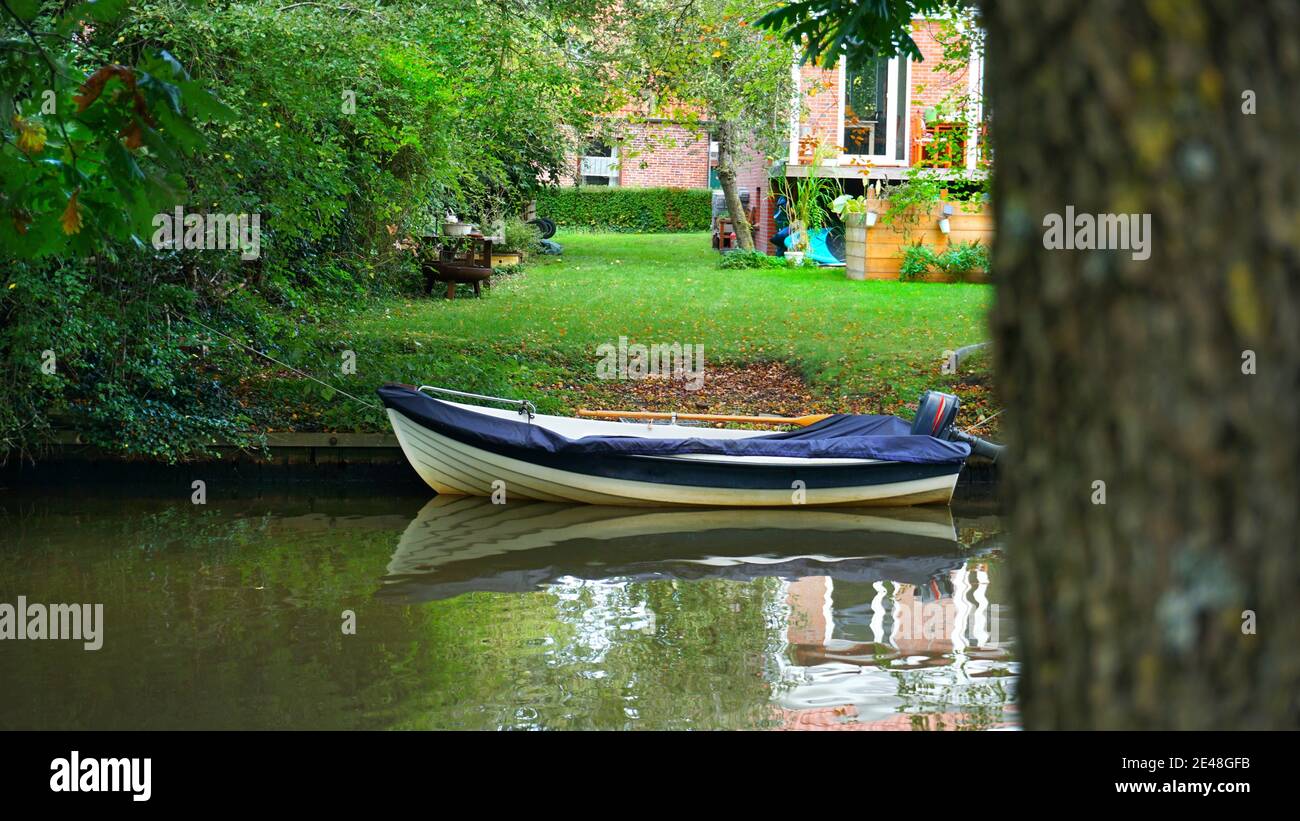 Typical motor boat in the canal directly in front of a house, Emden ...
