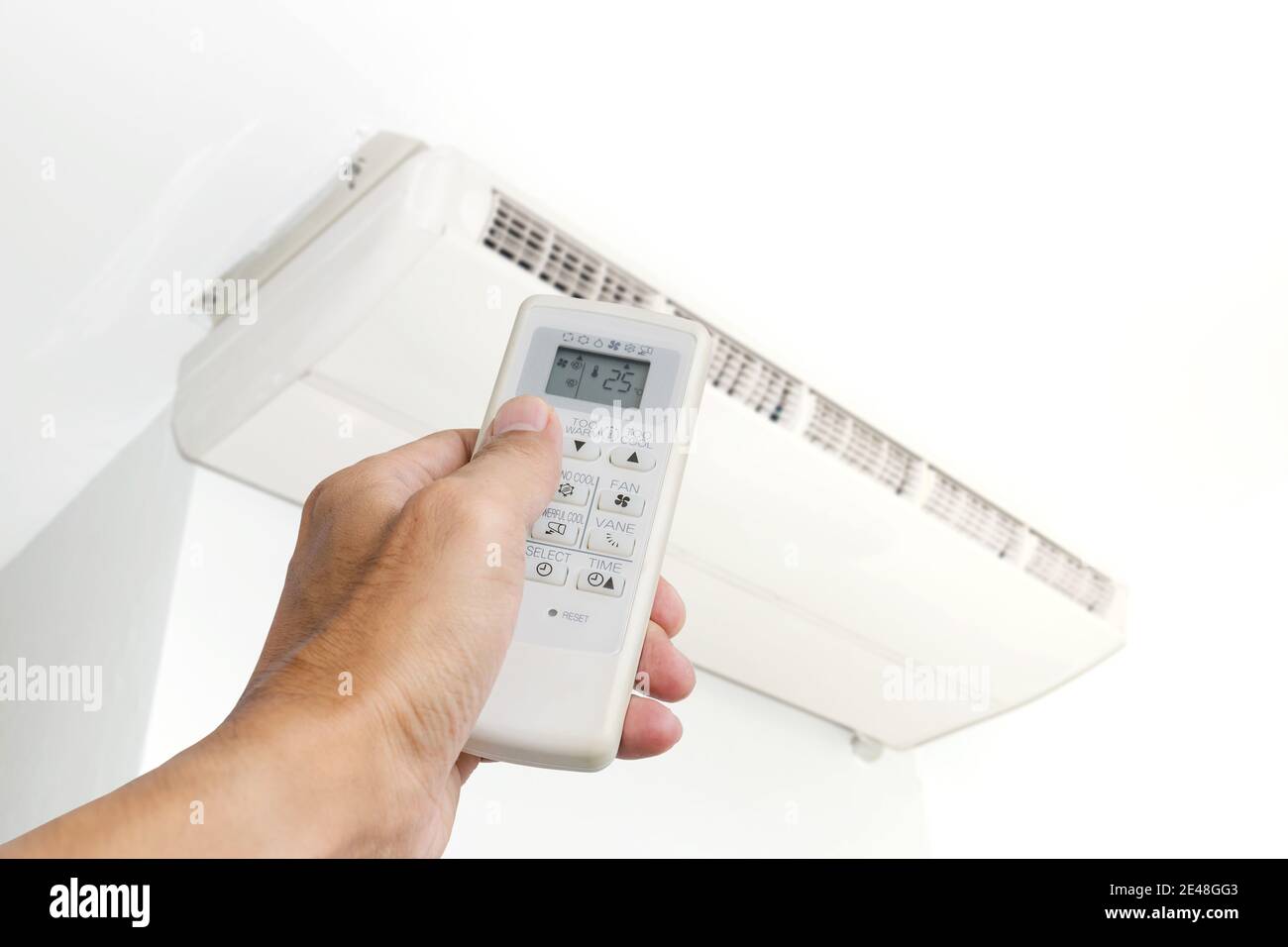 Hand holding the remote control to control the air conditioning ...