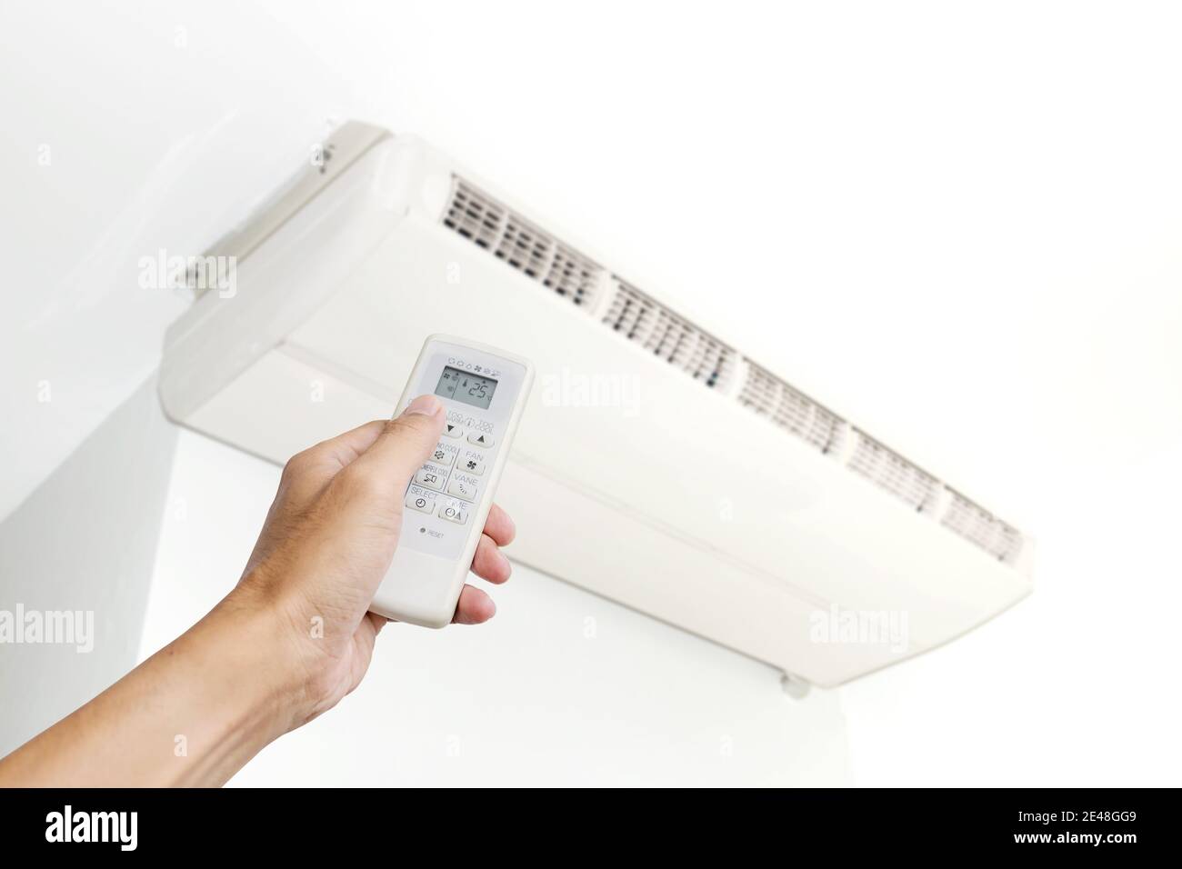 Hand holding the remote control to control the air conditioning ... Hand holding the remote control to control the air conditioning ...