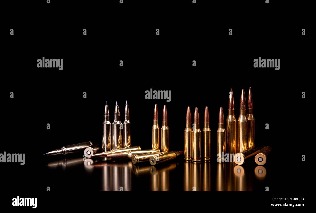 Bullet isolated on black background with reflexion. Rifle bullets close ...