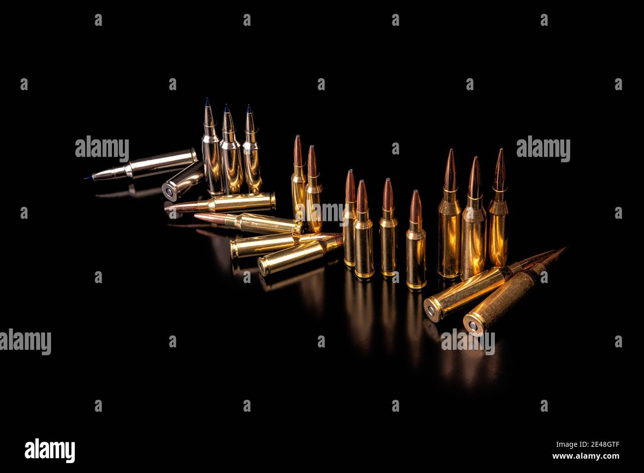 Bullet isolated on black background with reflexion. Rifle bullets close ...