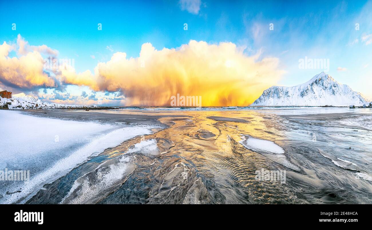 Outstanding winter scenery on Skagsanden beach with illuminated clouds during sunrise. Popular ...