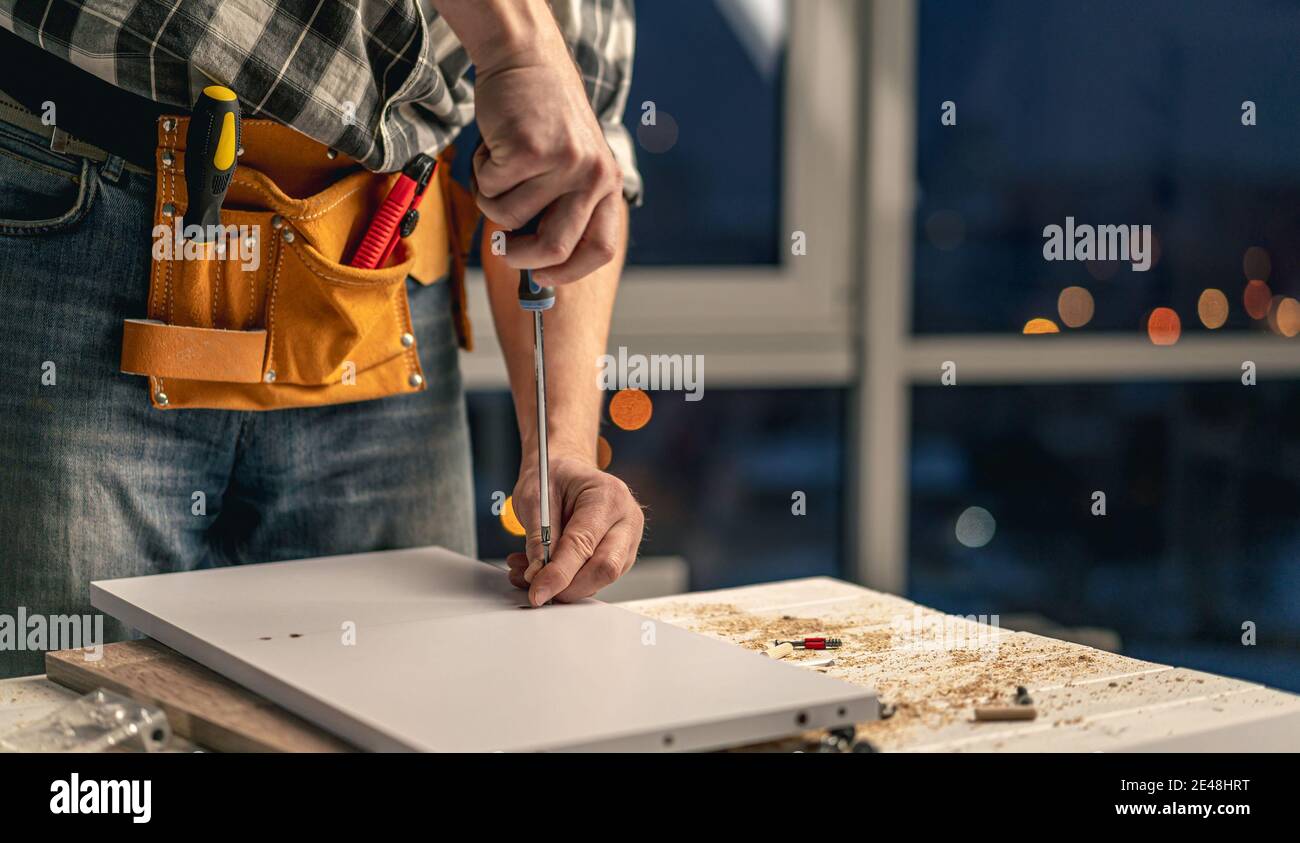 Man working during process of furniture manufacturing Stock Photo - Alamy