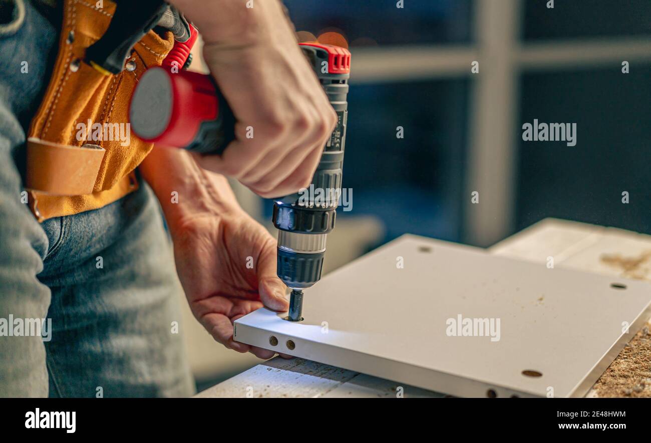 Man working during process of furniture manufacturing Stock Photo - Alamy