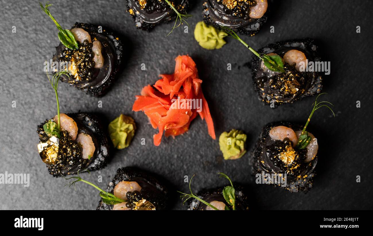 Sushi roll with nori, black rice, crab meat, cucumber, avocado, smoked ...