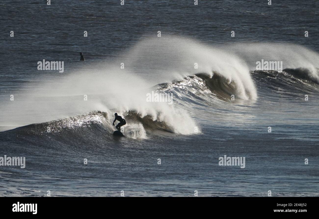Surfers take on the waves off Tynemouth beach, in Tyne and Wear Stock ...