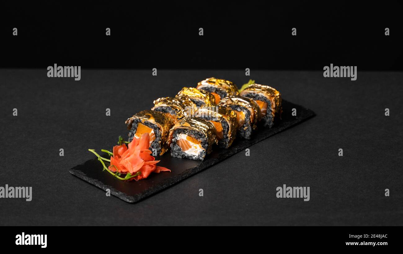 Custom sushi roll with nori, cuttlefish ink, fresh salmon, cream cheese ...