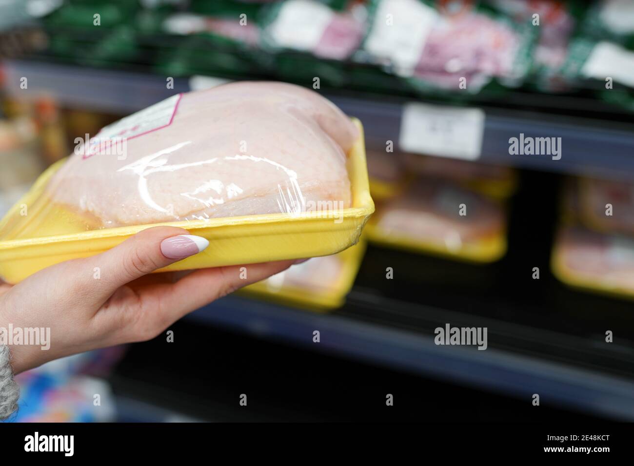 Image of packaged hen meat with woman hand in the supermarket Stock ...