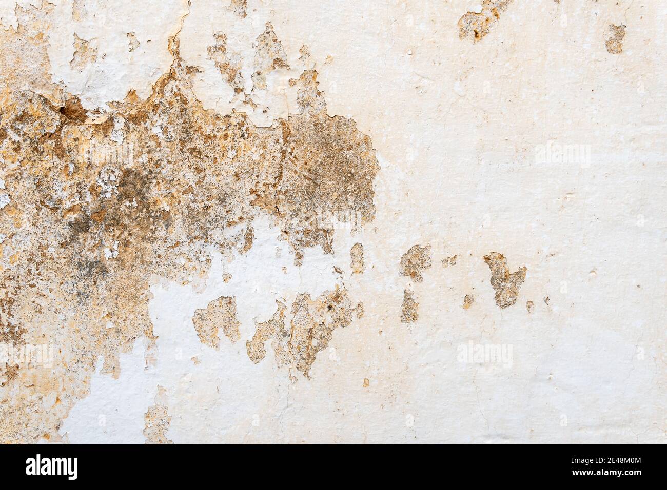 Close-up of the texture of an old and deteriorated lime whitewashed ...