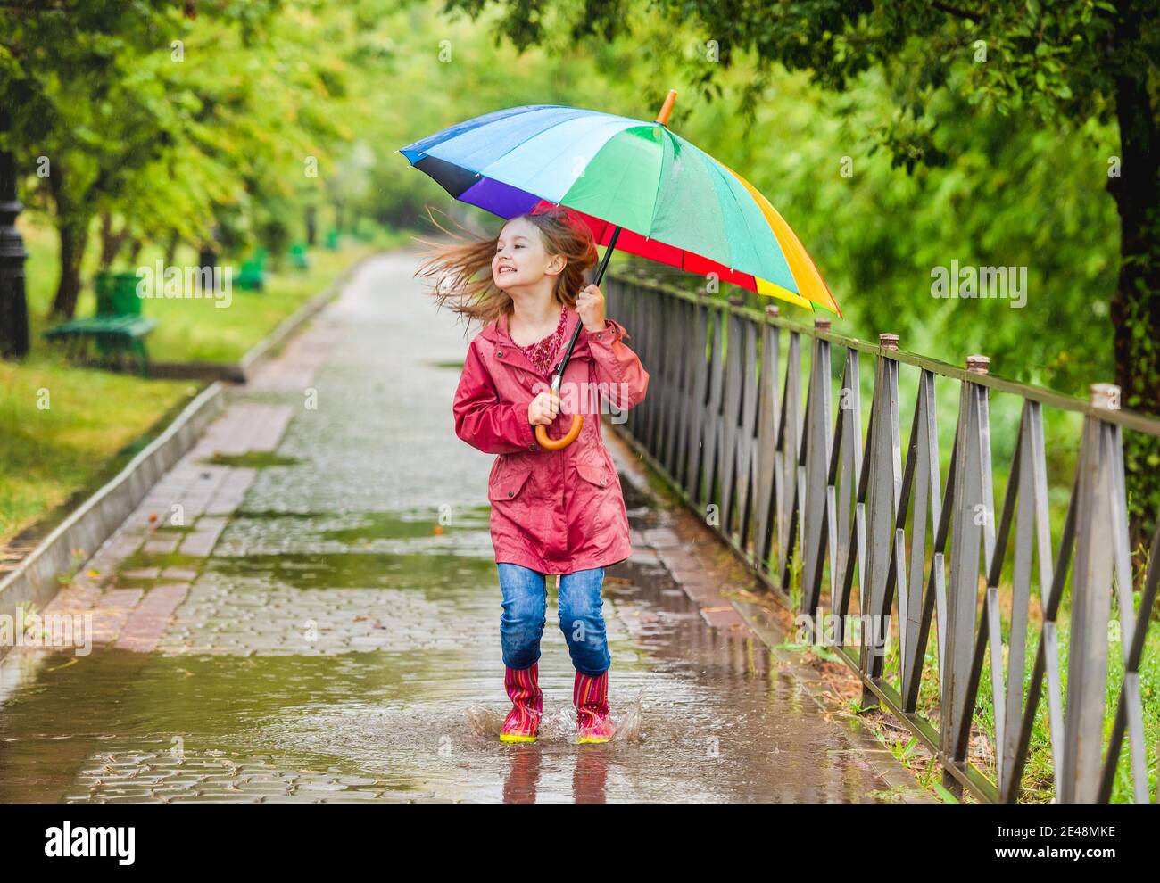 Kid child jumping puddle water splash hi-res stock photography and ...