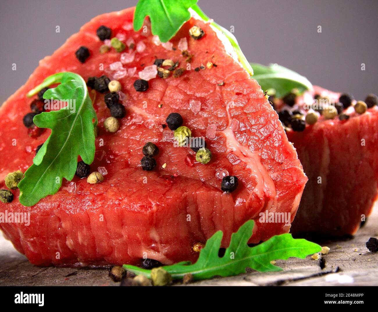 Rare cooked beefsteak with garnish Stock Photo - Alamy