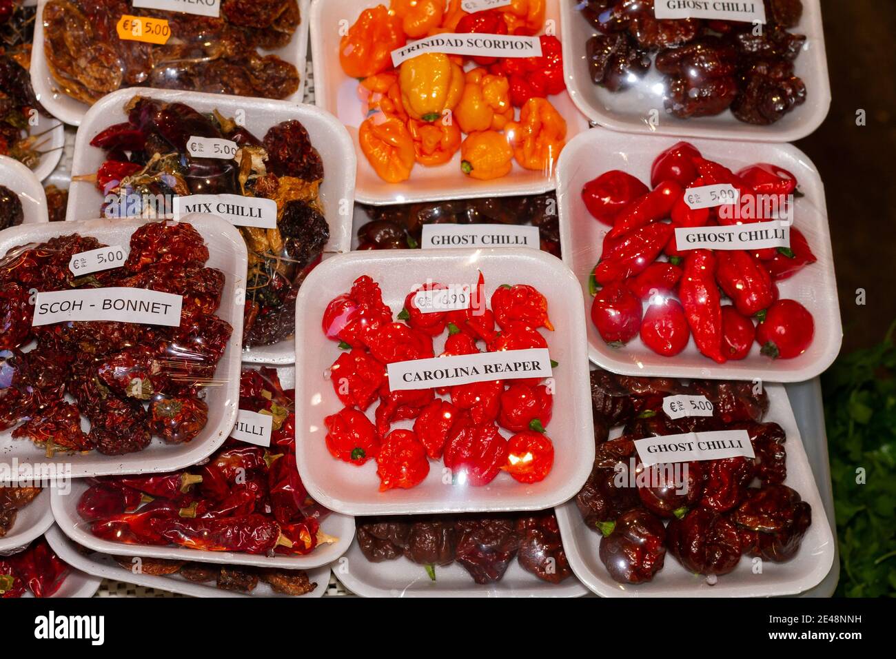 Different kinds of peppers in plastic trays ready for sale at the ...