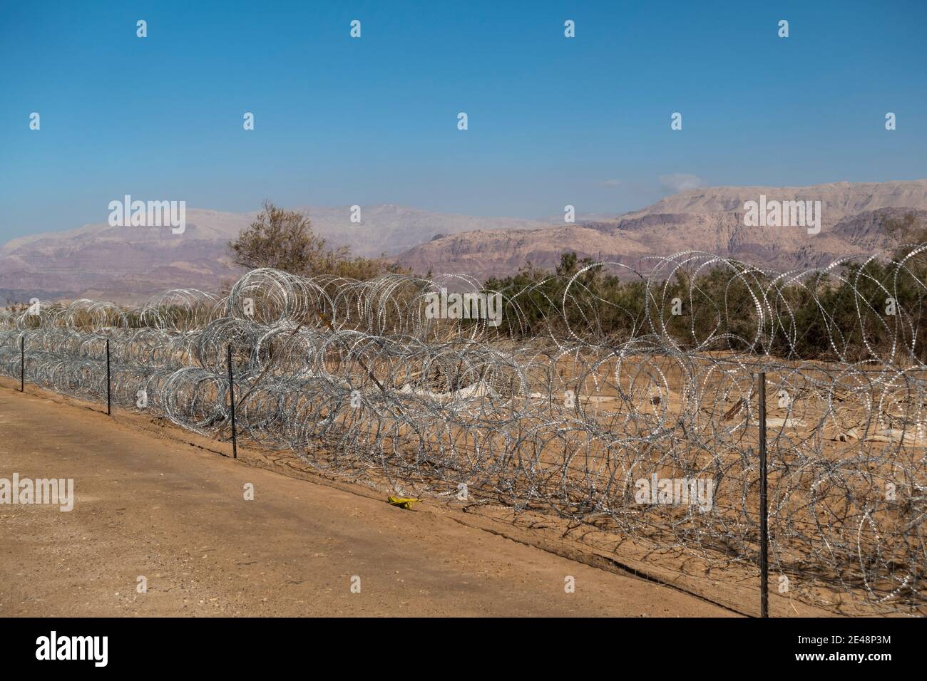Coiled barbed wire fence at the Israeli border with Jordan in the ...