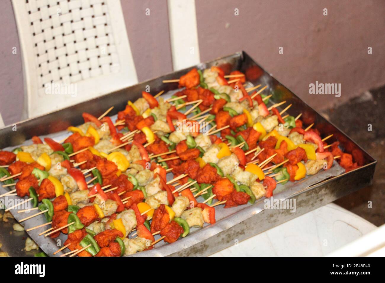 Indian sticky food in a pot.it stands white chair .pink and black mixed ...