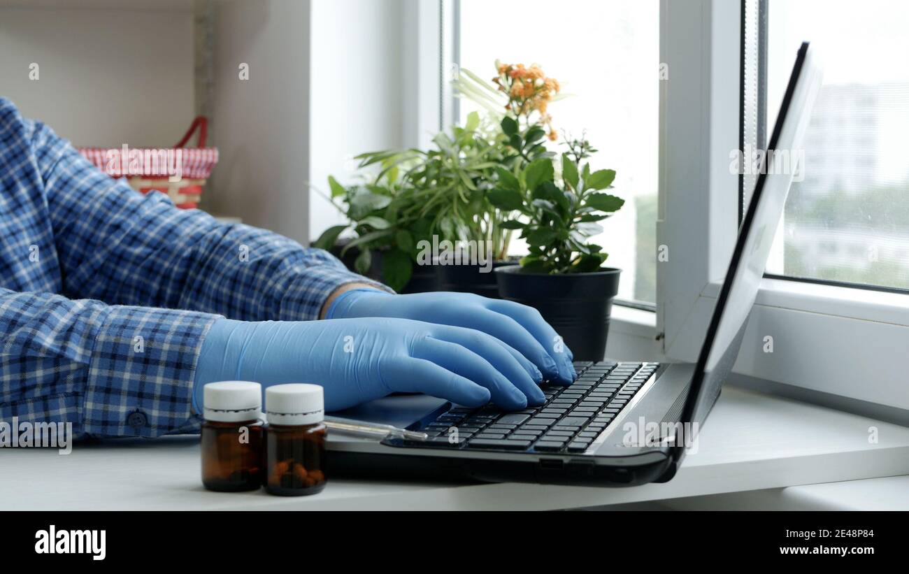 Sick Man Working with Laptop Wearing Protective Gloves Stock Photo - Alamy