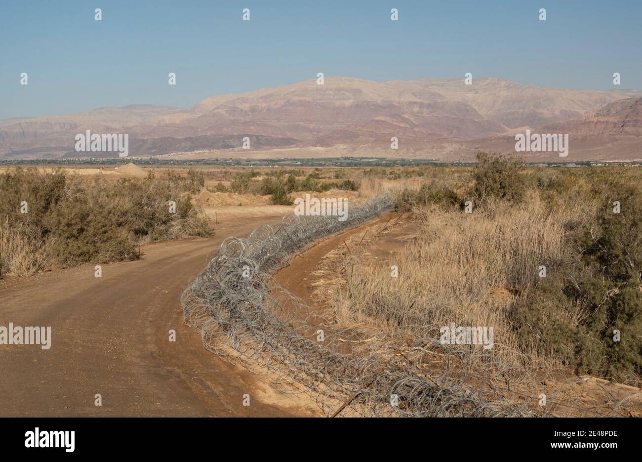 Coiled barbed wire fence at the Israeli border with Jordan in the ...