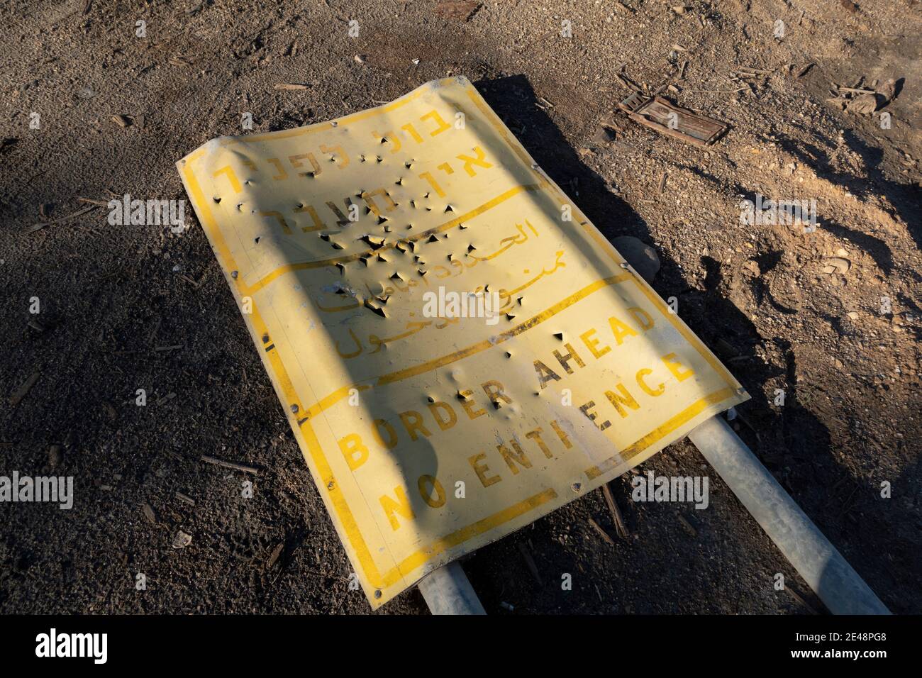 Abandoned border warning sign riddled with bullet holes at the Israeli ...