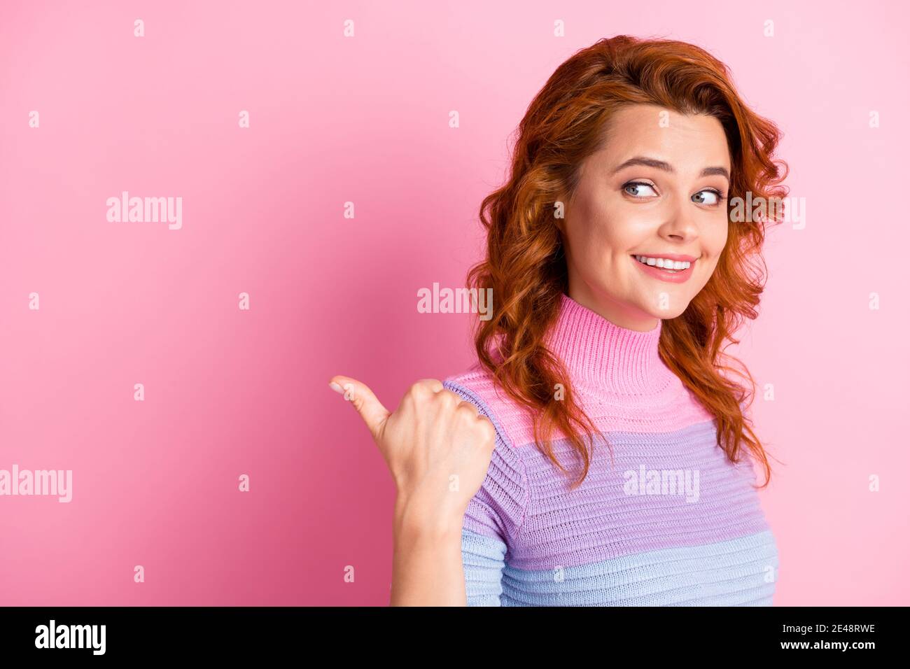Photo portrait of woman pointing thumb looking behind back at blank ...