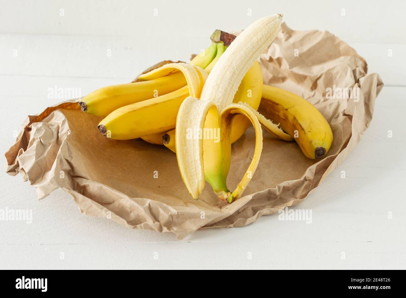 Ripe bunch of bananas in paper bag. Healthy eating concept Stock Photo ...
