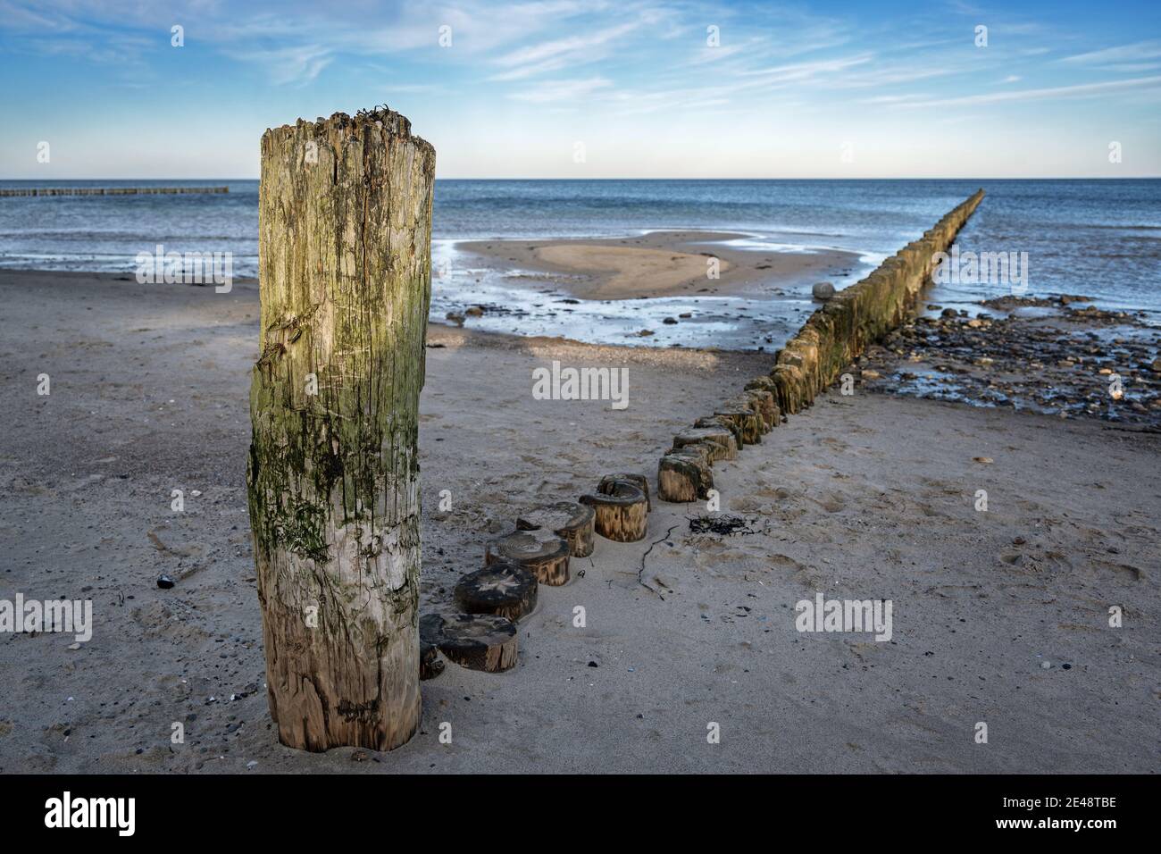 Weathered wooden groynes on the beach of the Baltic Sea in northern ...