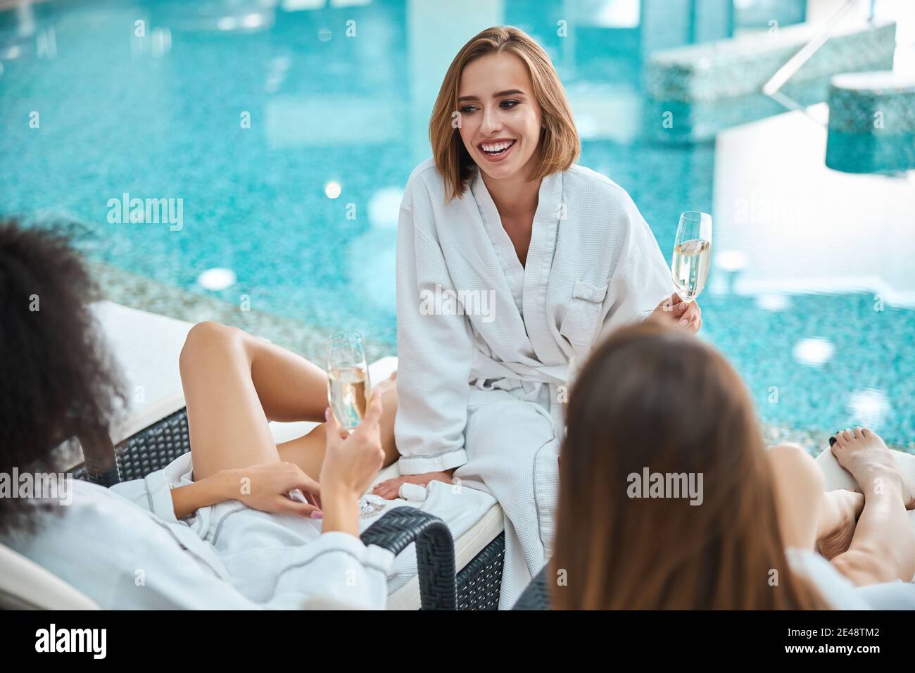 Joyful young woman spending quality time with friends at resort Stock ...