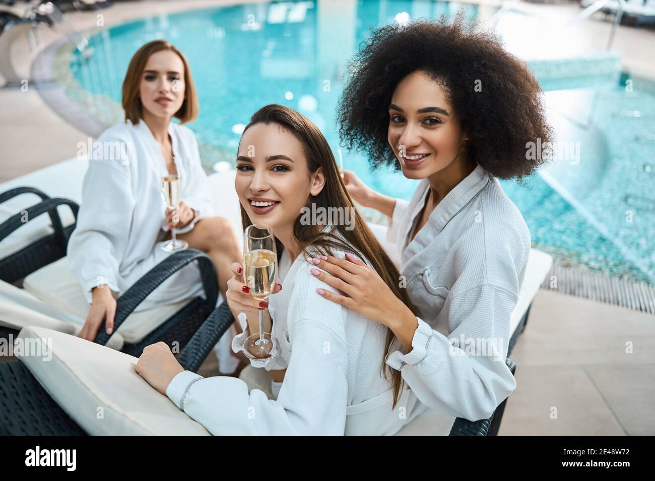 Best girlfriends enjoying vacation by the pool Stock Photo - Alamy