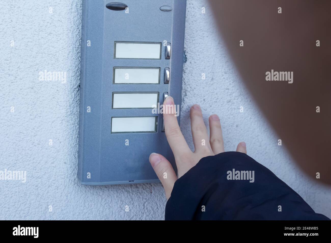 Woman ringing doorbell hi-res stock photography and images - Alamy