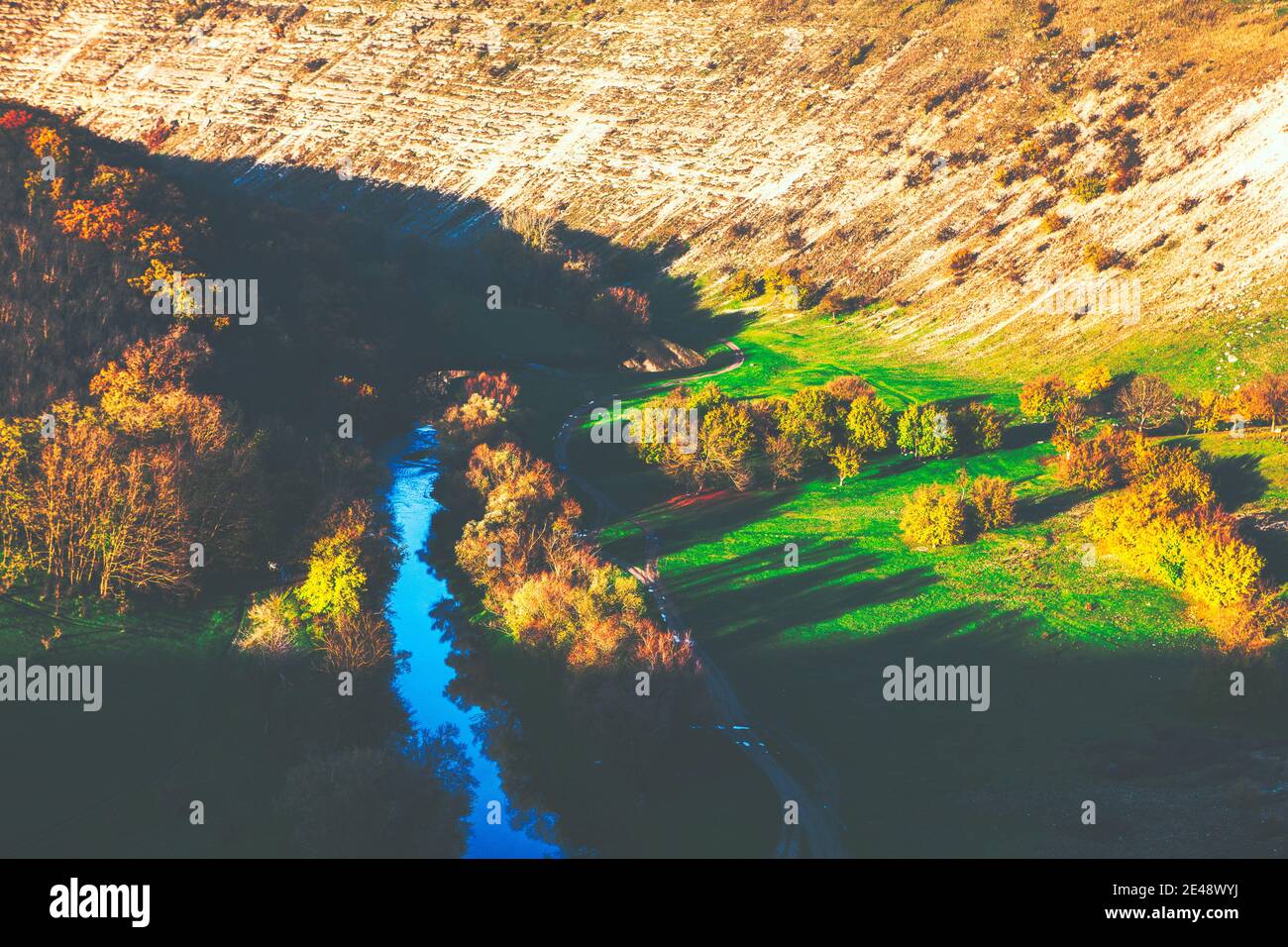 Cinematic nature . Aerial view of riverside valley and rocky hills ...